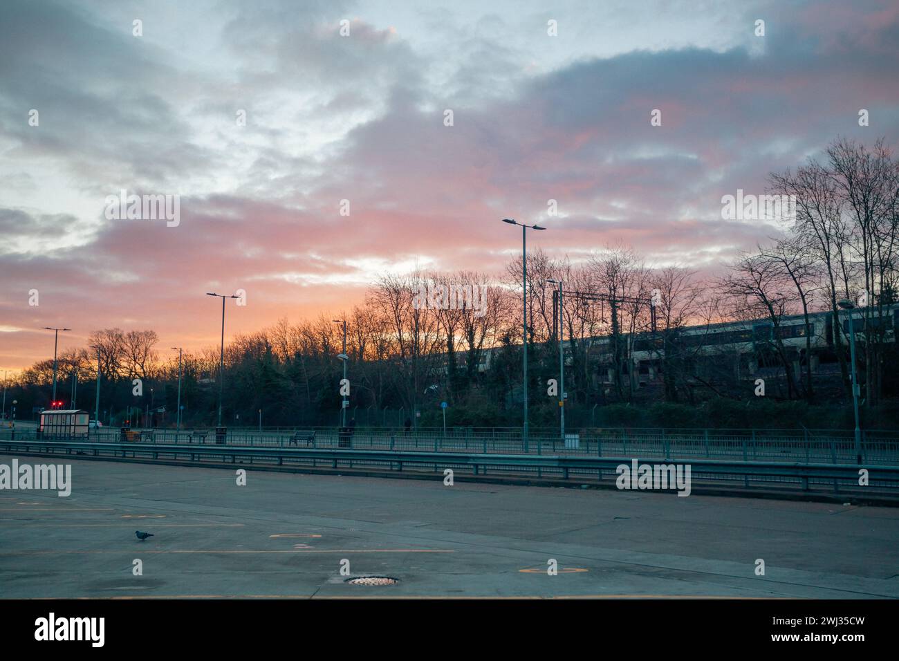 Early morning street view from Bus line to train track as it speeds ...