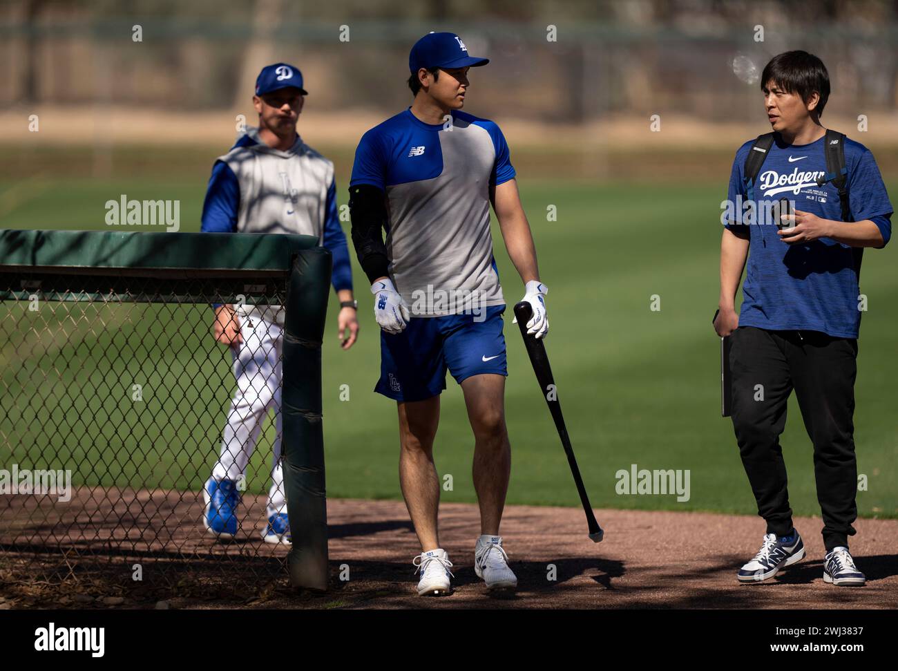 Los Angeles Dodgers' Shohei Ohtani walks with interpreter Ippei ...