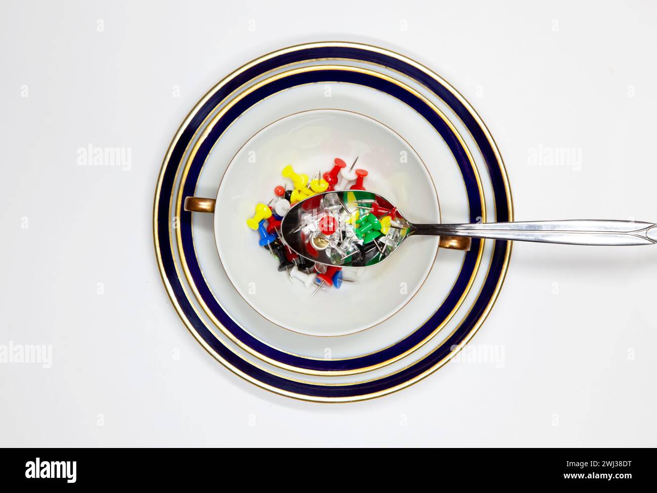 Multi-colored straight pins. Multi Colored Pins on the plate with spoon ...