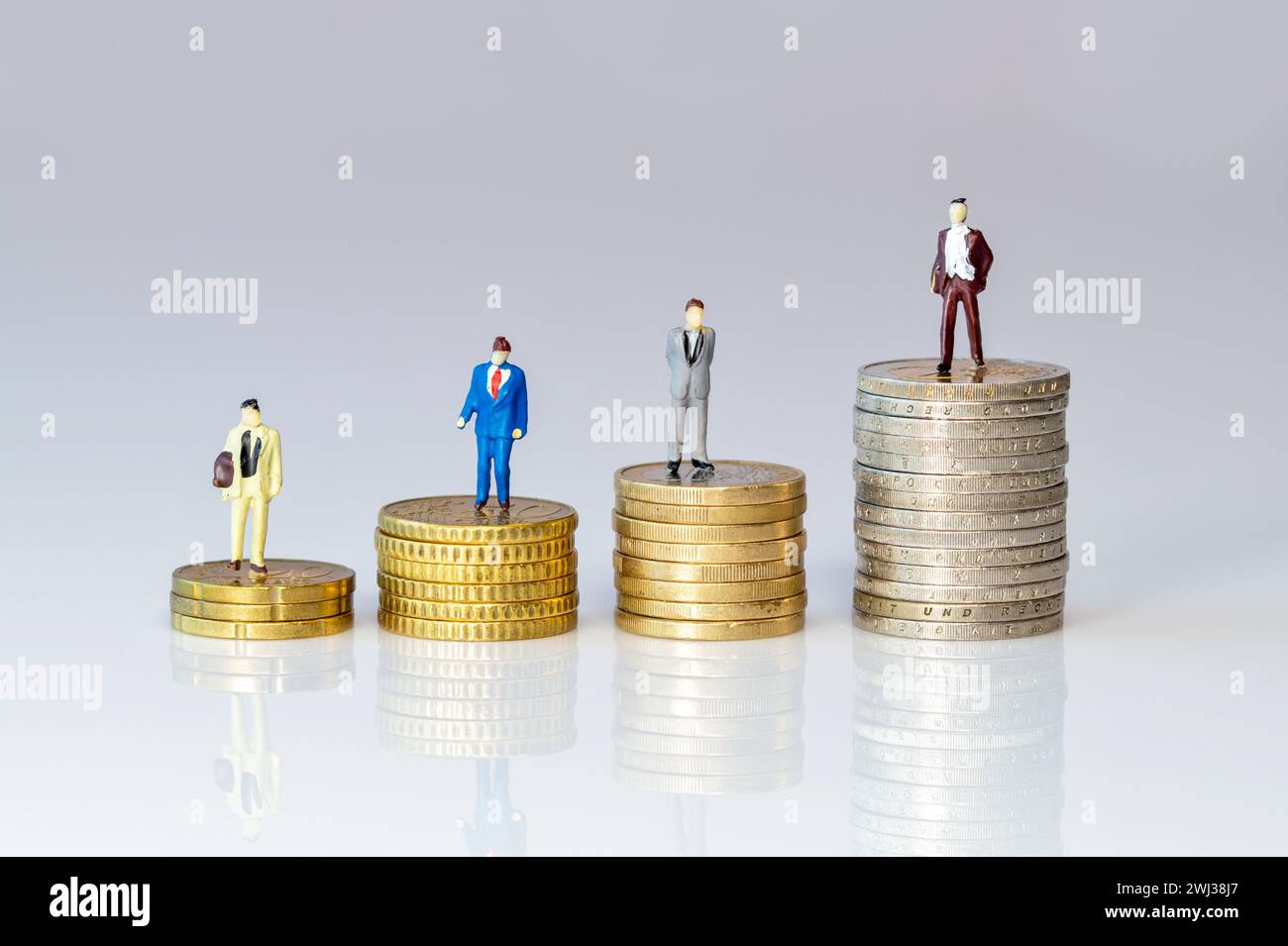 Business toy people standing on stack of Euro coins. figurine symbol ...