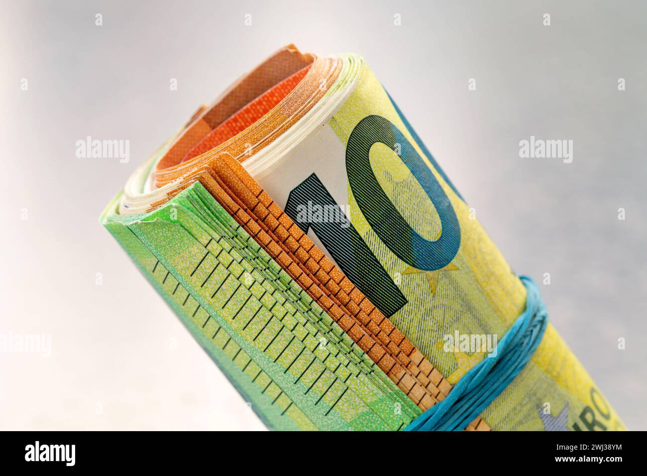 Money roll Euro. 100 and 50 Euro bills twisted into tube and tied with ...