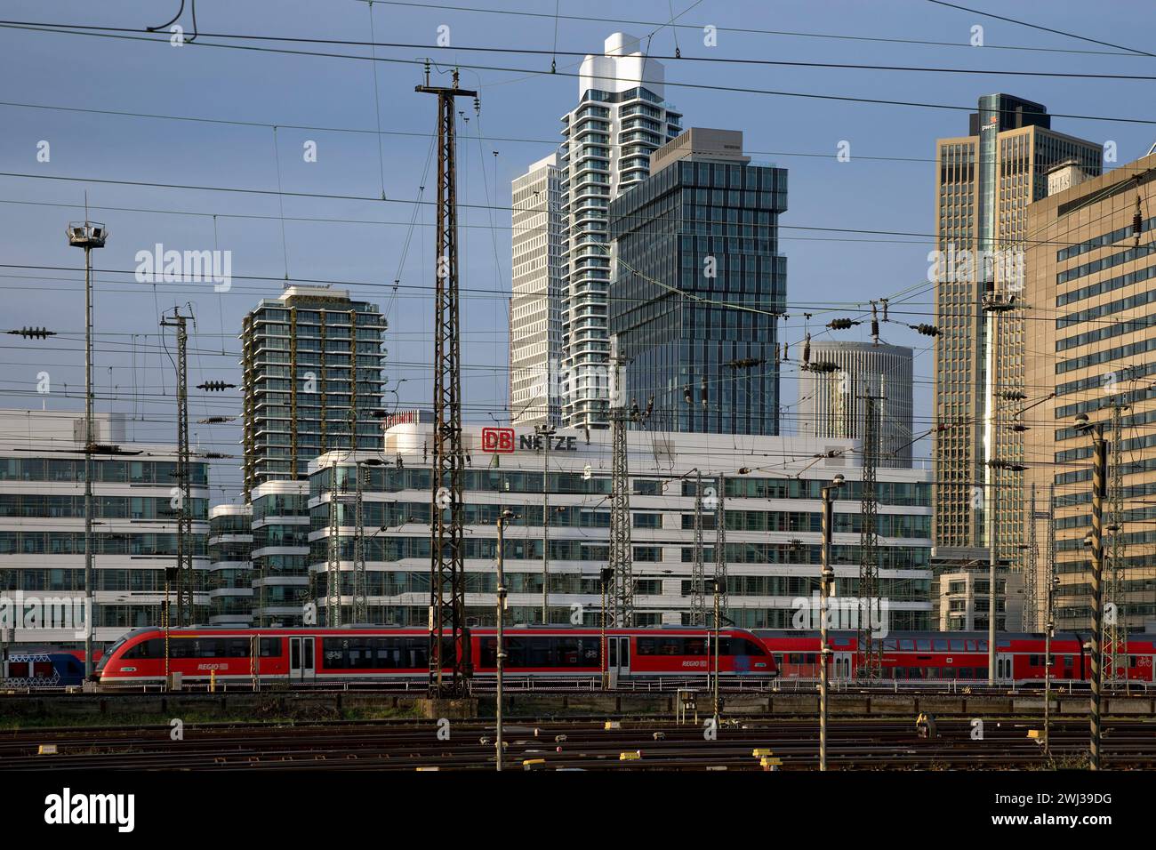 Local train in front of DB Netze and high-rise buildings, Frankfurt am ...