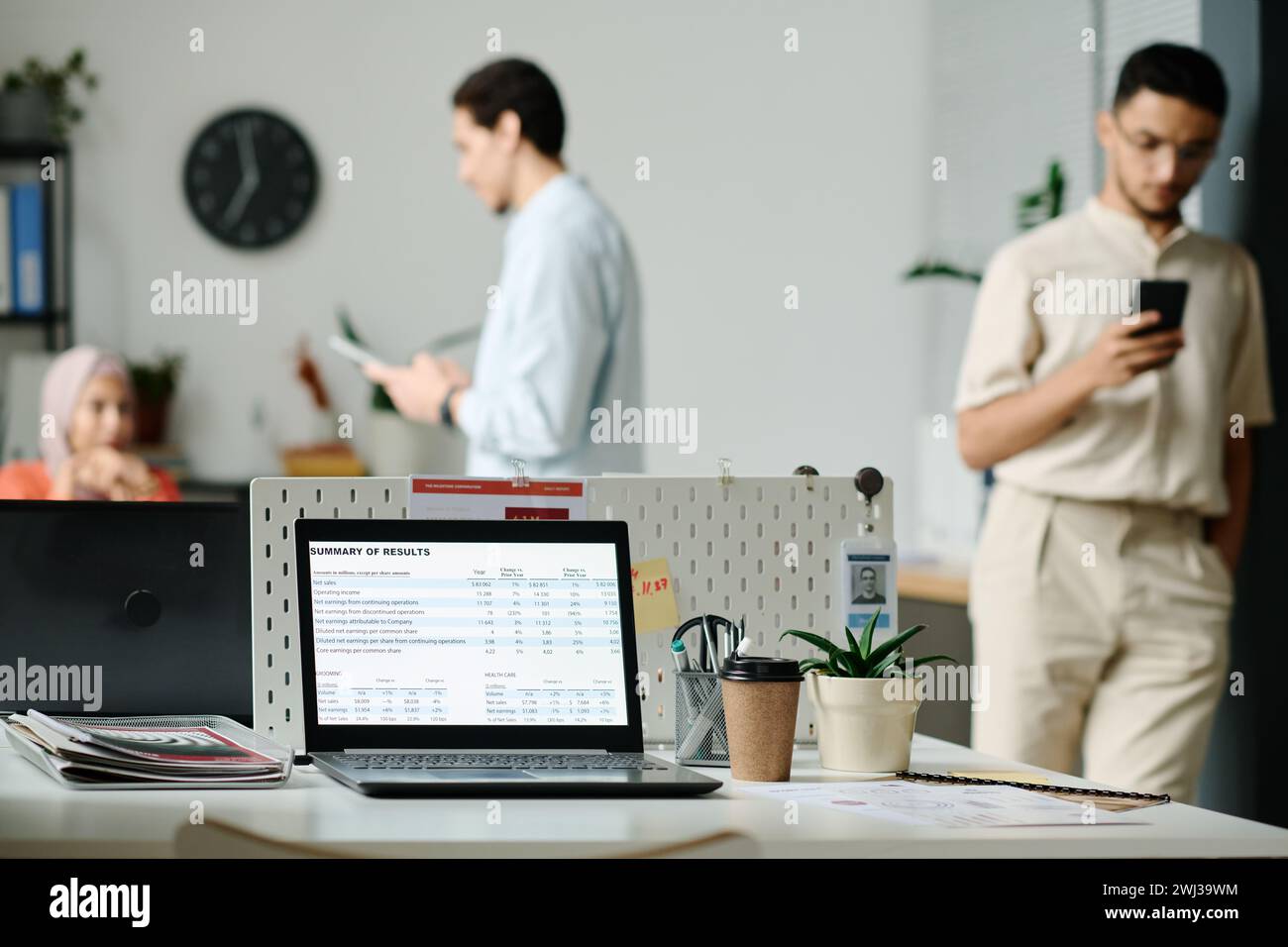 Laptop with summary of results on screen standing on desk which is ...