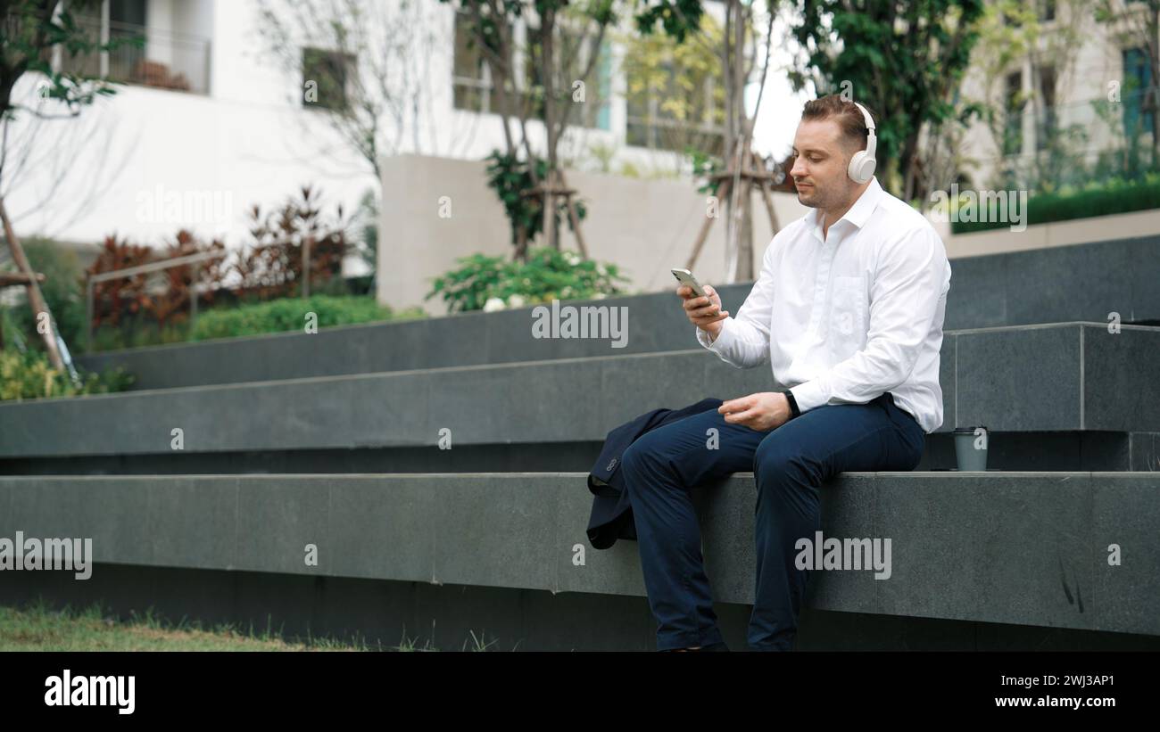 Smart businessman wear headphone to listen relaxed music while take off ...