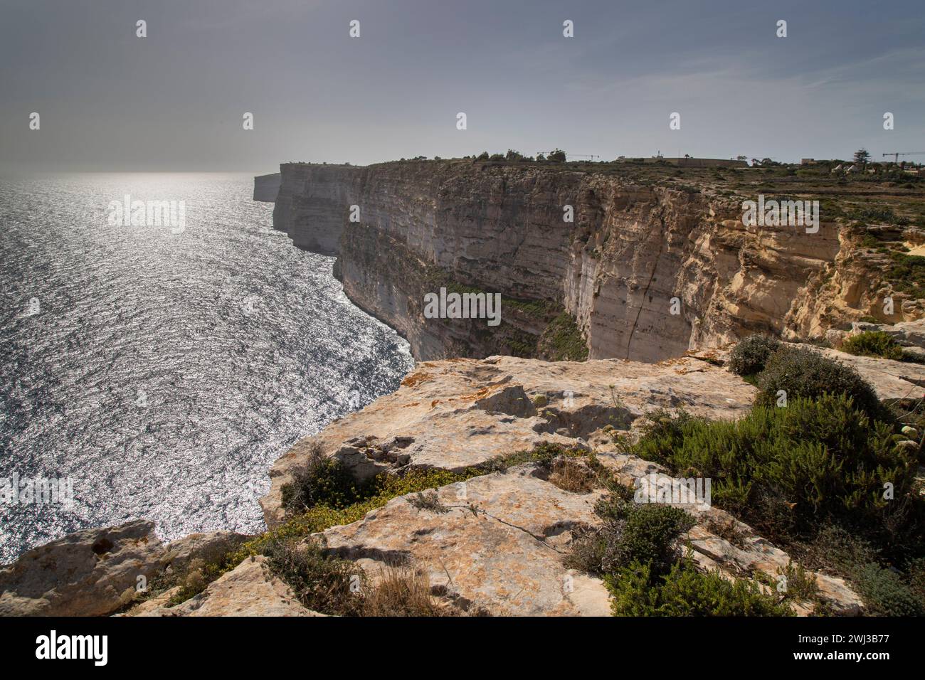 The sunset over the ocean with beautiful sunlight in Ta Cenc cliffs in ...