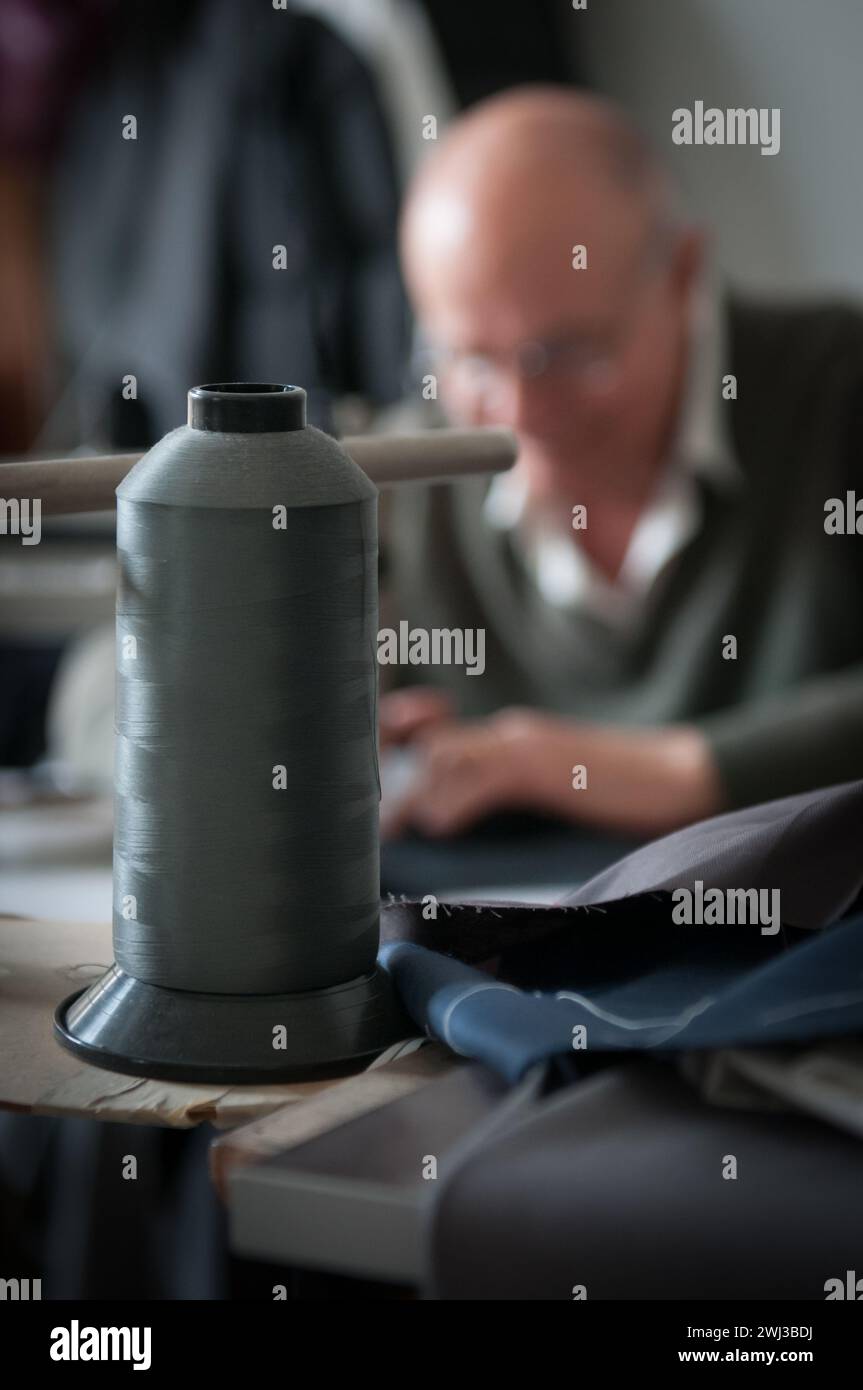 Unrecognized tailor using sewing machine, sewing clothes, Man at ...