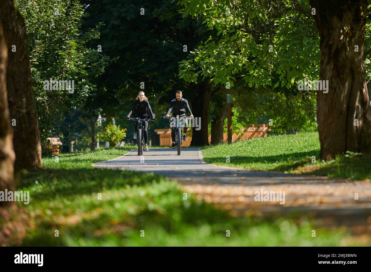 A blissful couple, adorned in professional cycling gear, enjoys a ...