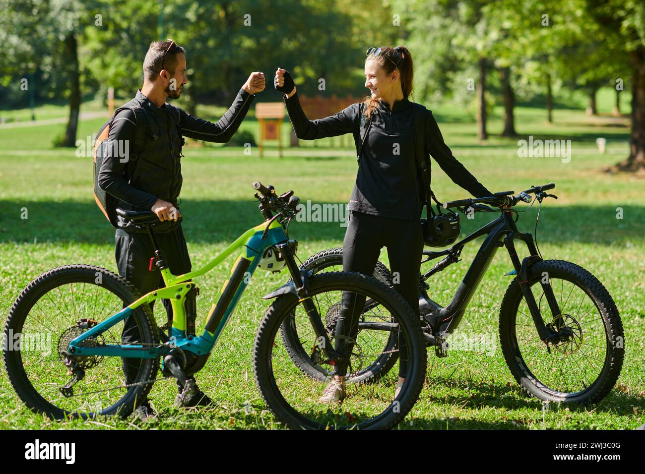 A sweet couple, adorned in cycling gear, rides their bicycles, their ...