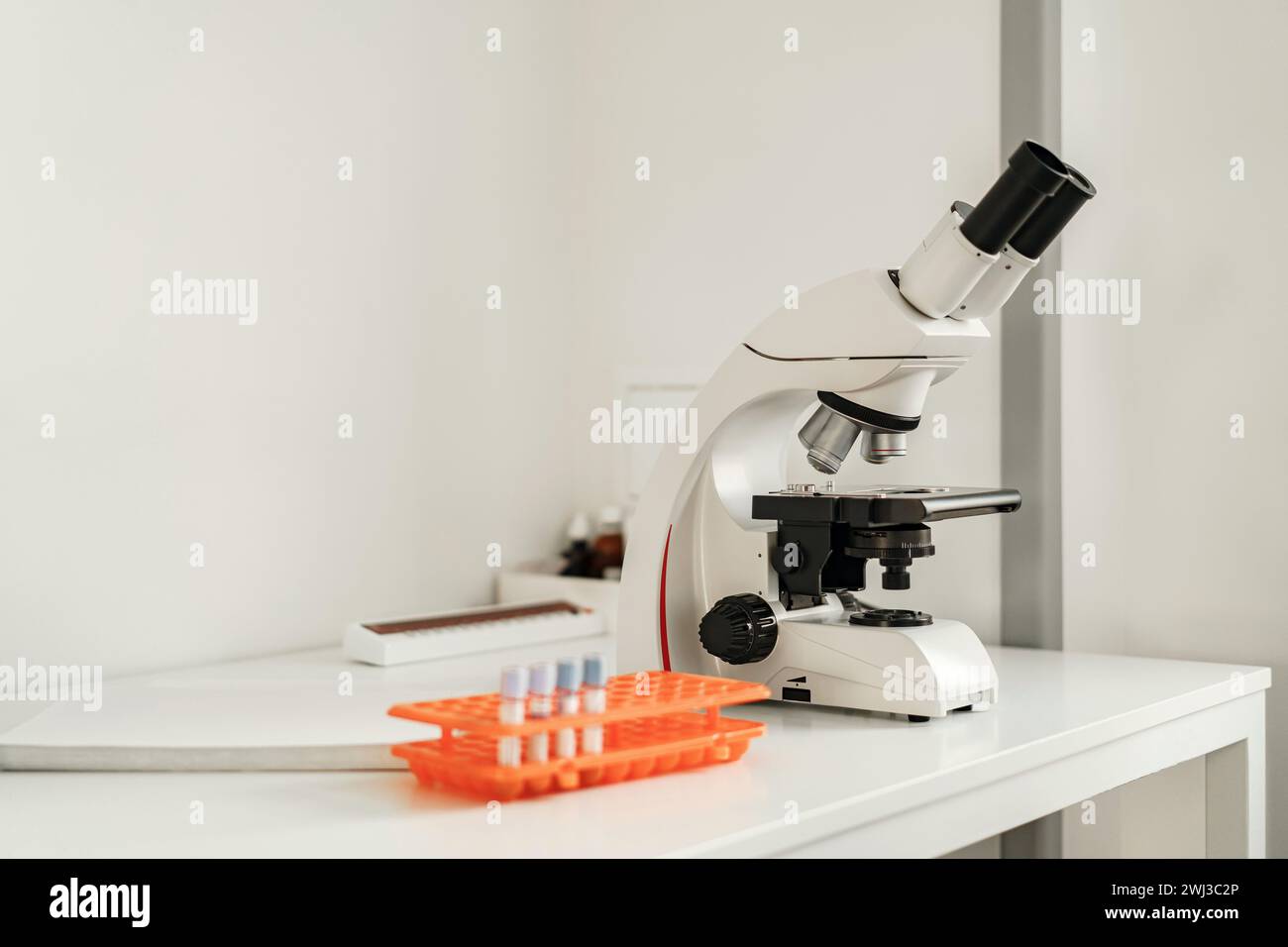 Modern medical research laboratory with microscope and test tubes with ...