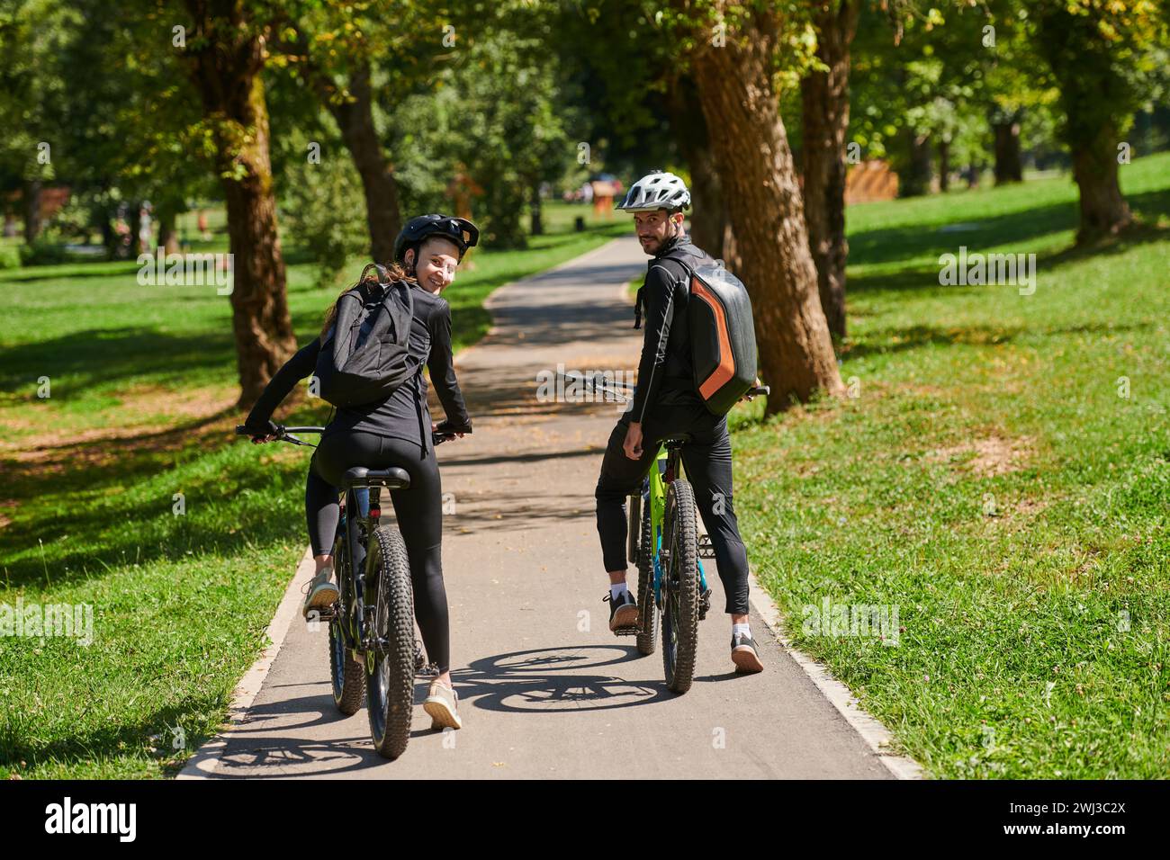 A blissful couple, adorned in professional cycling gear, enjoys a ...