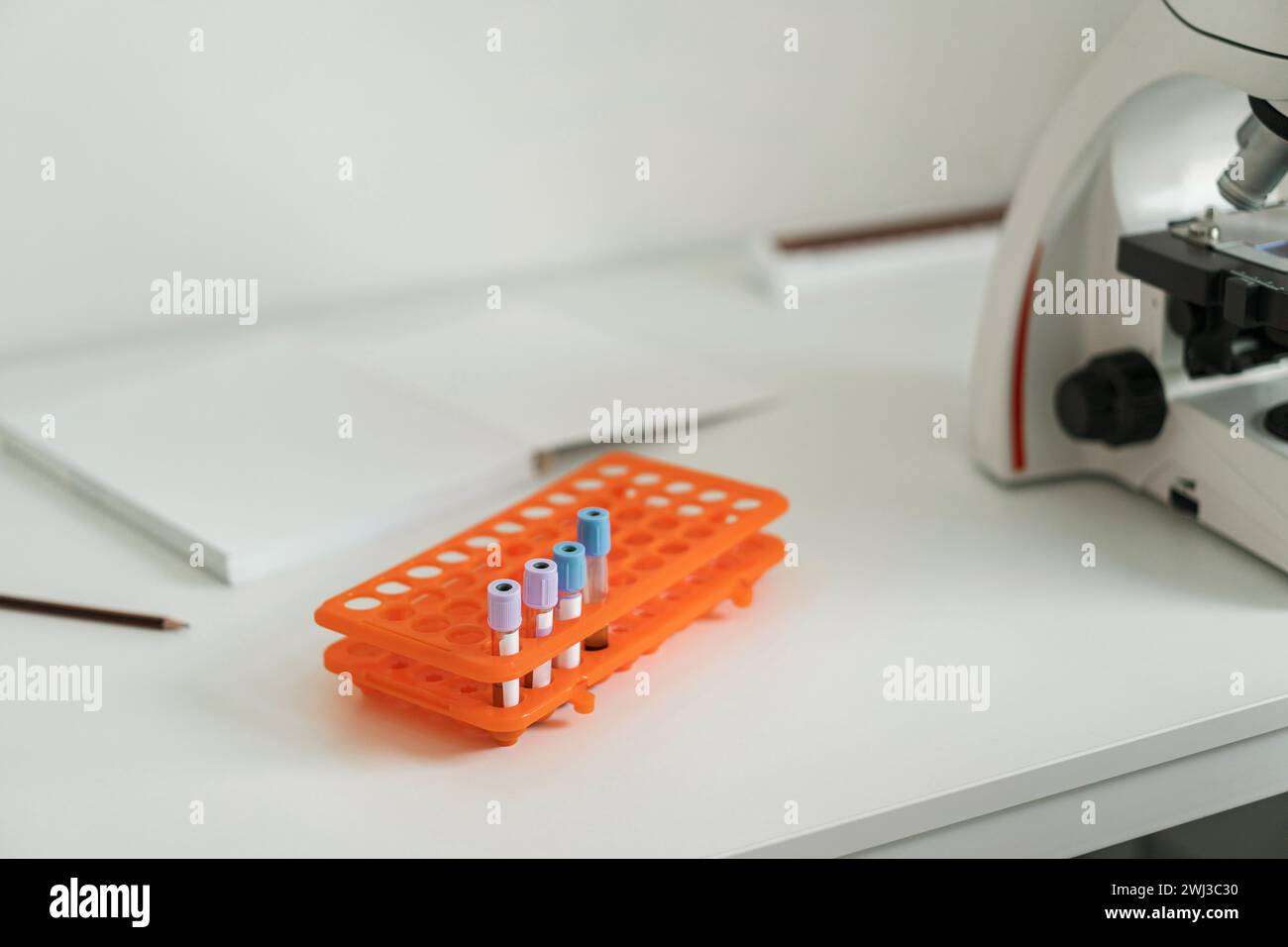 Modern medical research laboratory with microscope and test tubes with ...