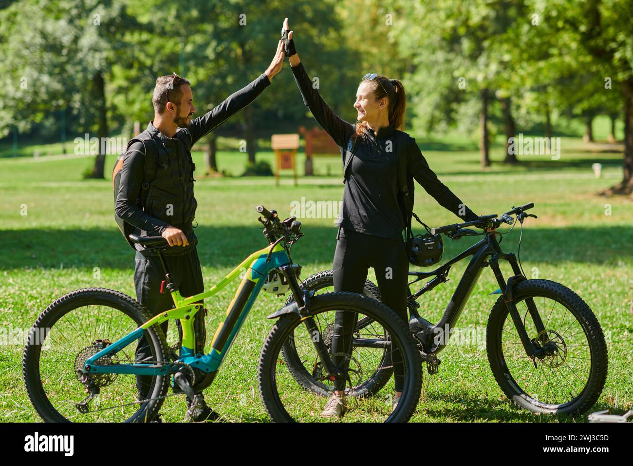 A sweet couple, adorned in cycling gear, rides their bicycles, their ...