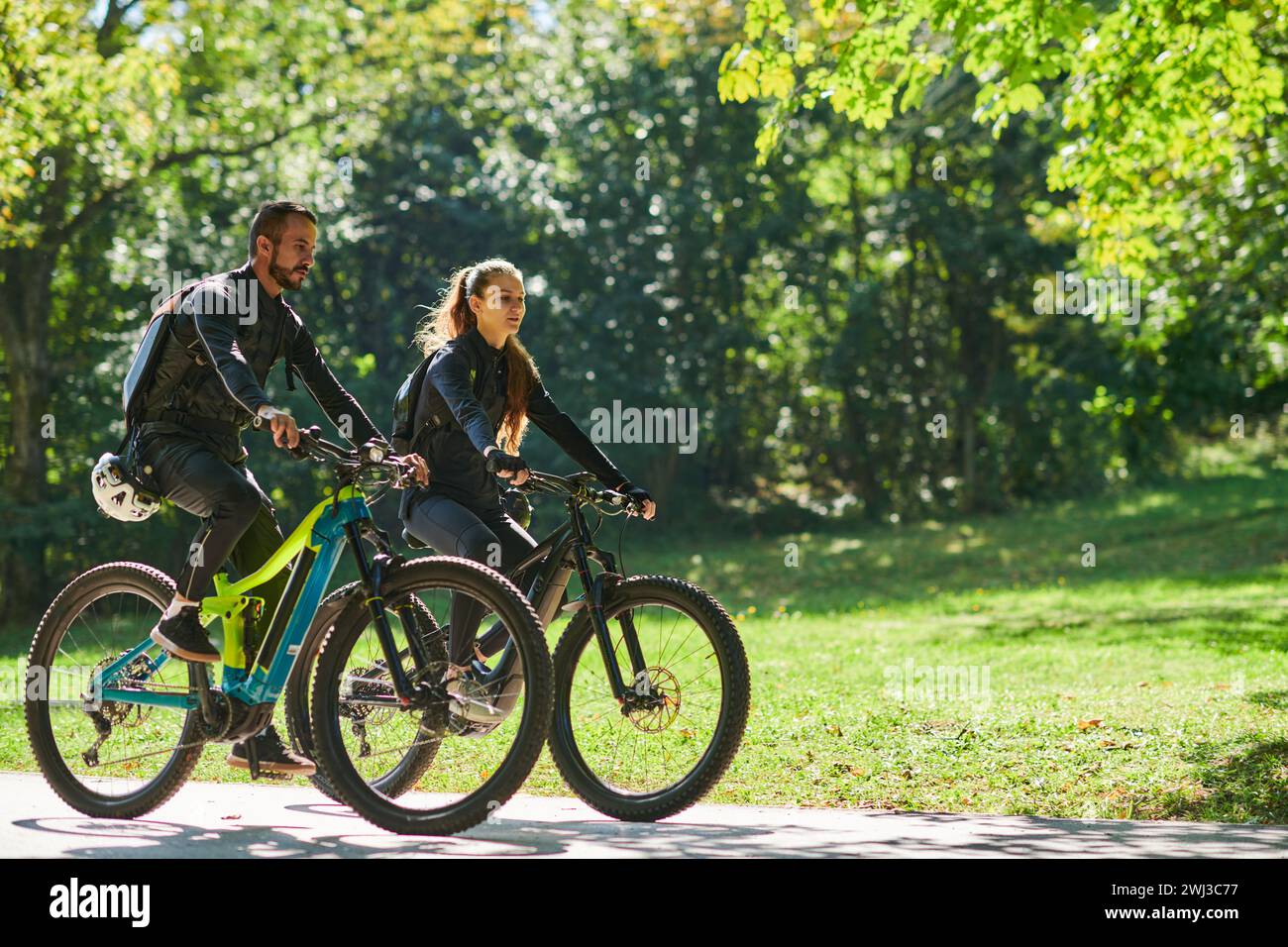 A blissful couple, adorned in professional cycling gear, enjoys a ...