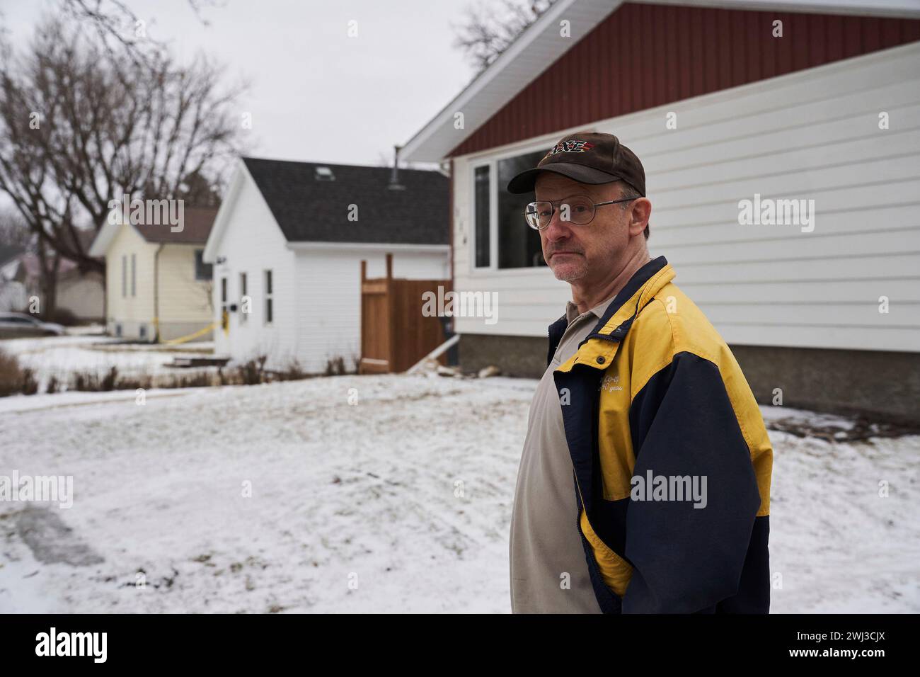 Neighbor Randy McFarlane looks over at the scene of an ongoing ...