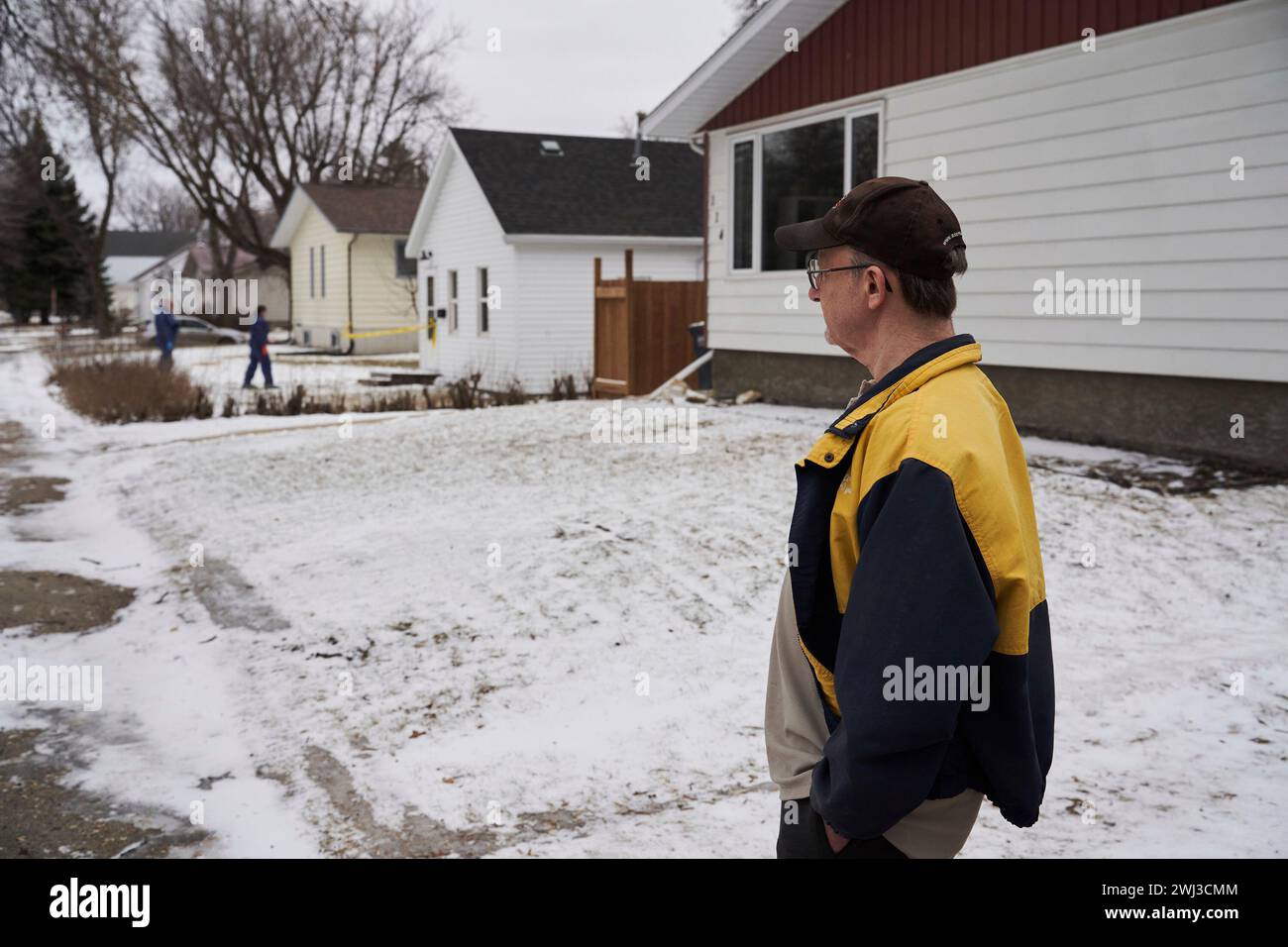Neighbor Randy McFarlane looks over at the scene of an ongoing ...