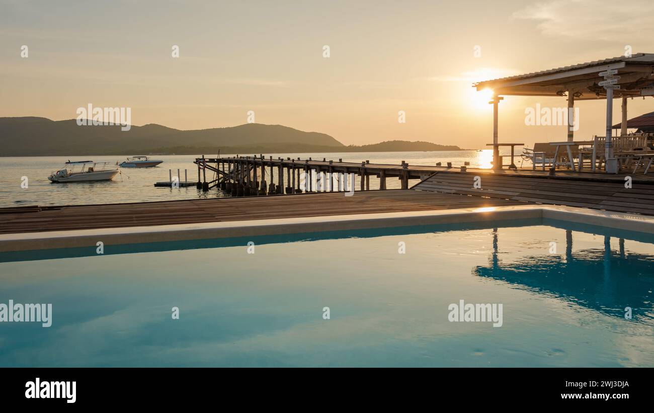 Swimming pool and wooden pier in the ocean during sunset in Samaesan ...