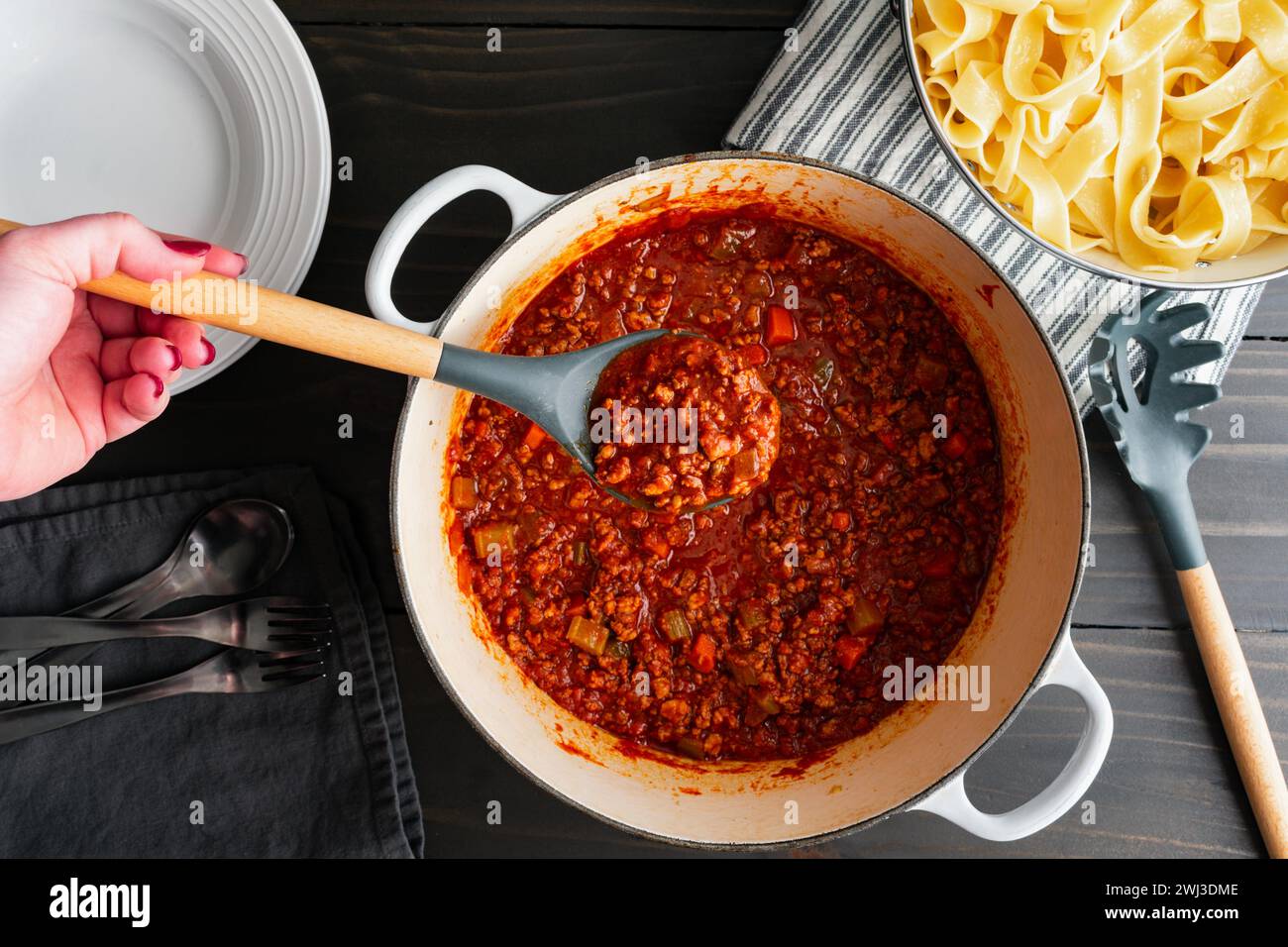 Hand Holding a Serving Spoon of Authentic Bolognese Sauce: Ragu alla ...