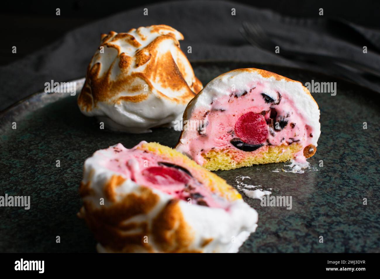 Sliced Mini Baked Alaska with a Cherry Center: Scoop of pink ice cream ...