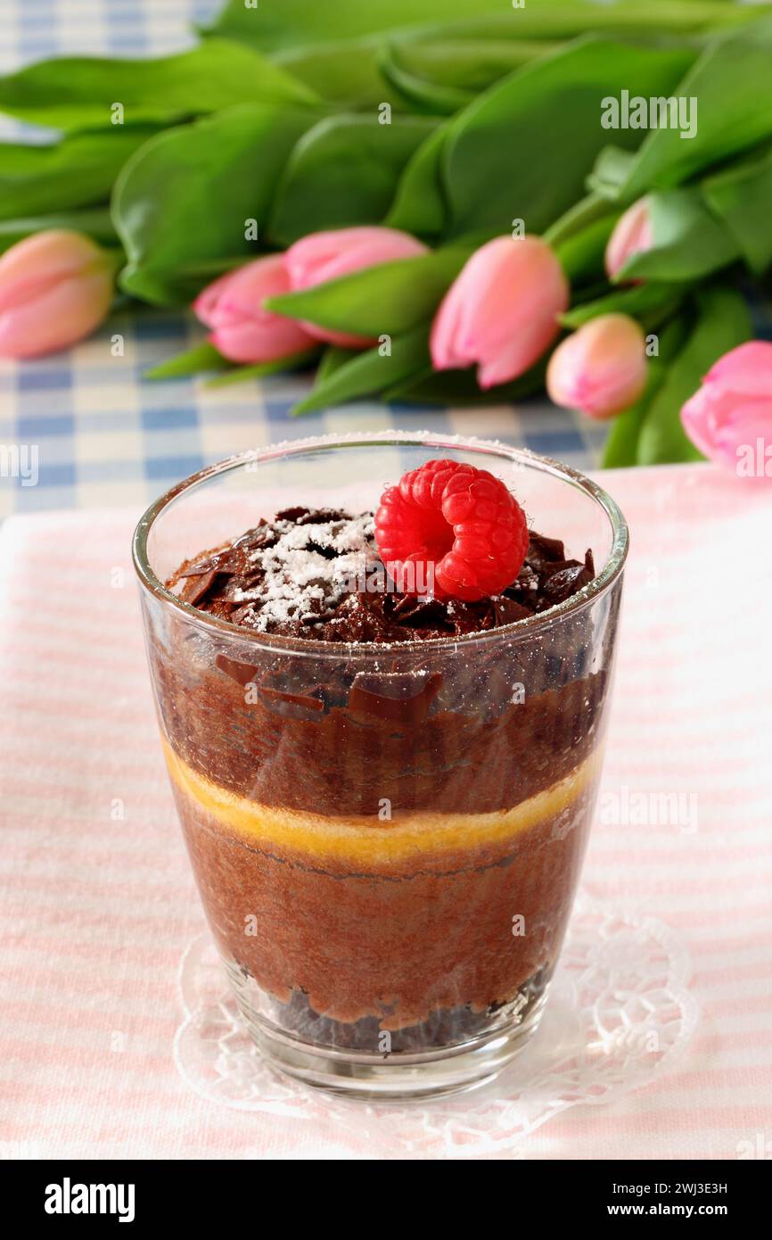 Chocolate dessert with raspberry and tulips Stock Photo - Alamy
