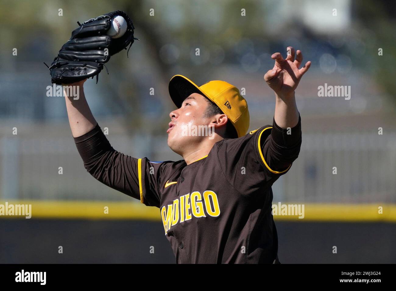 San Diego Padres relief pitcher Yuki Matsui, of Japan, grabs a ball ...