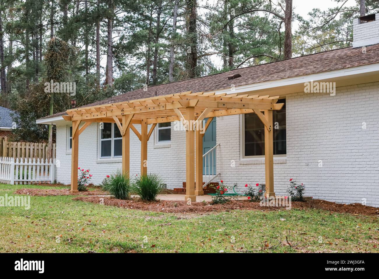 The rear back exterior of a newly painted and renovated white brick ...