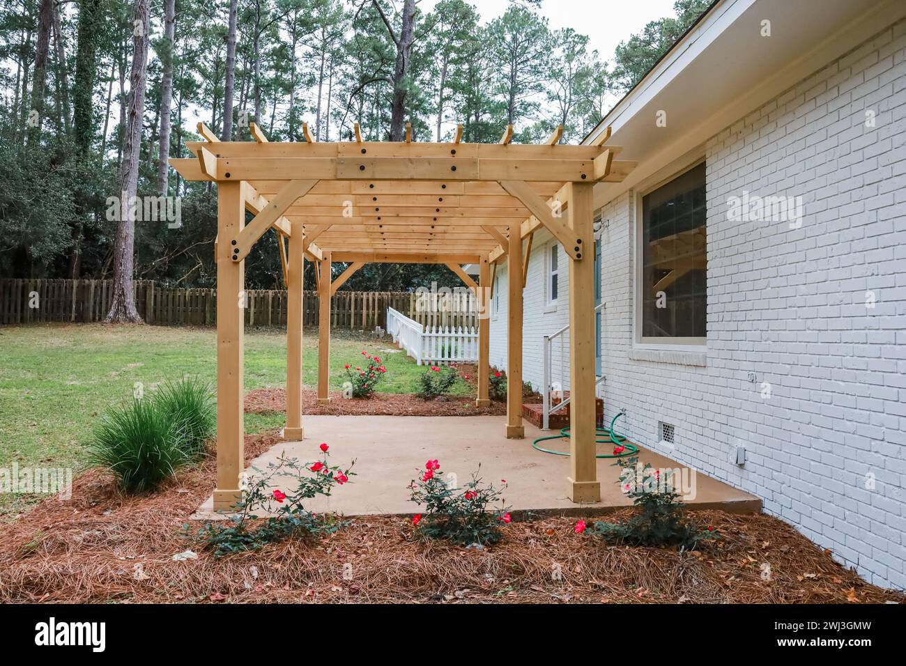 The rear back exterior of a newly painted and renovated white brick ...