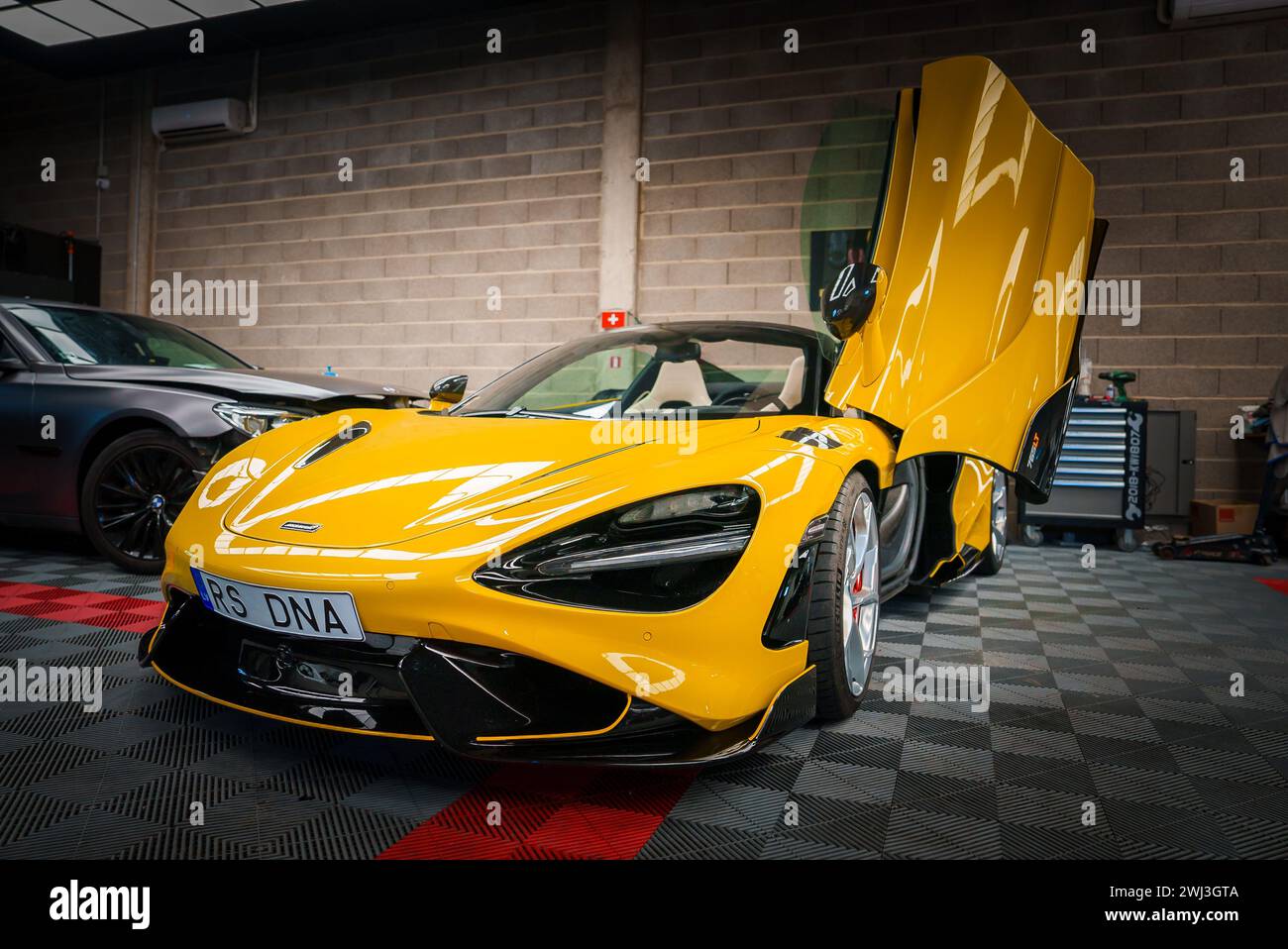 Yellow McLaren 765LT, featuring Dihedral Doors, parked in a Tuning ...