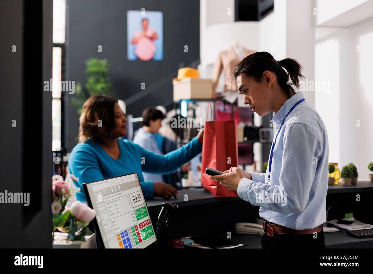 African american client paying for stylish wear, standing at counter ...