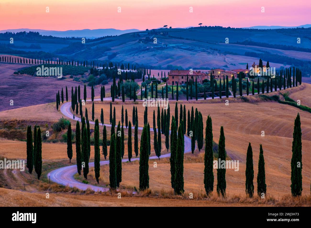 Tuscany landscape with grain fields, cypress trees on the hills at ...