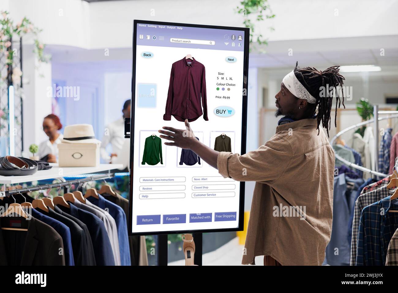 African american client selects clothes on touch screen board in ...