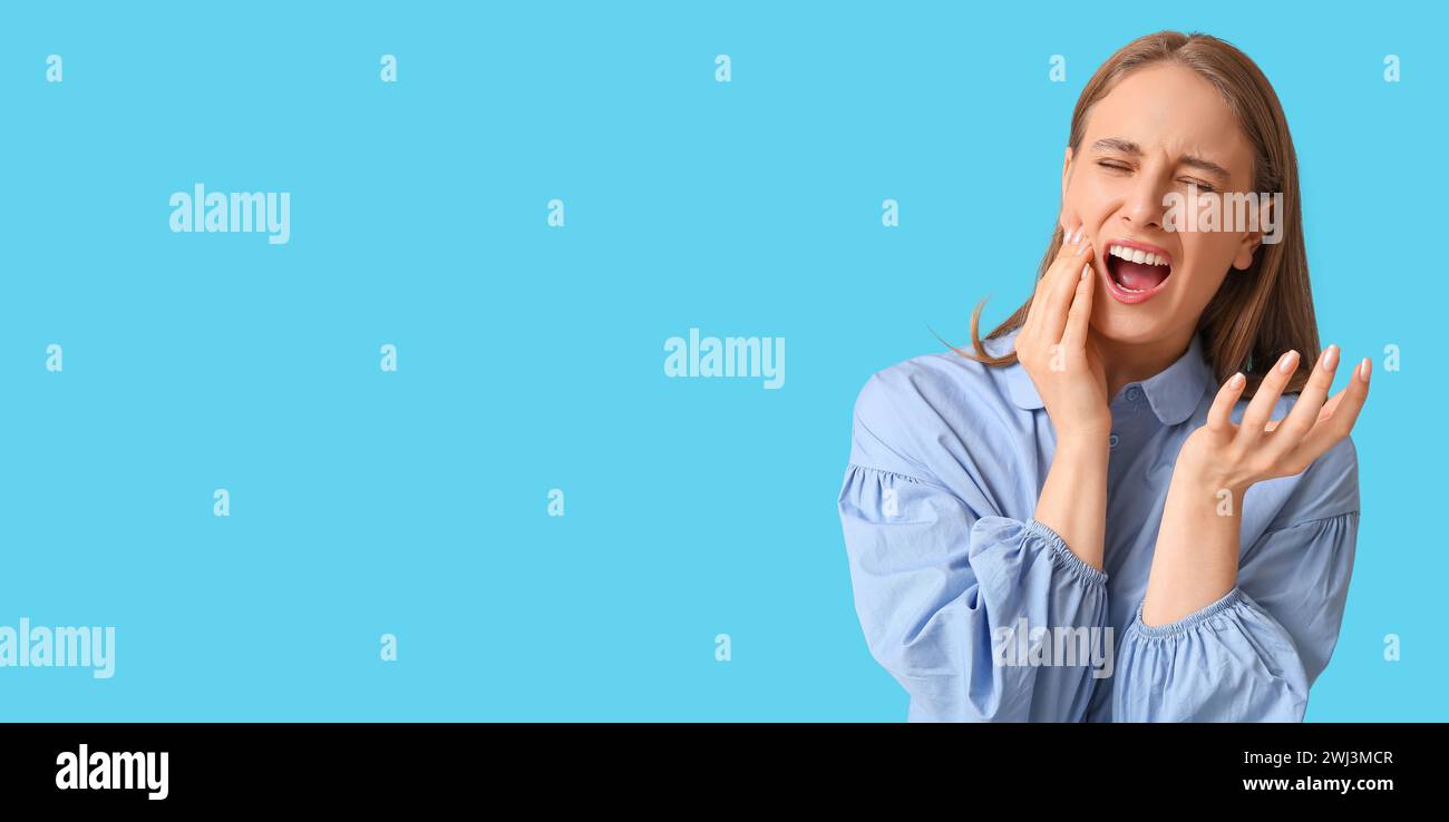 Young woman feeling tooth ache on light blue background with space for ...