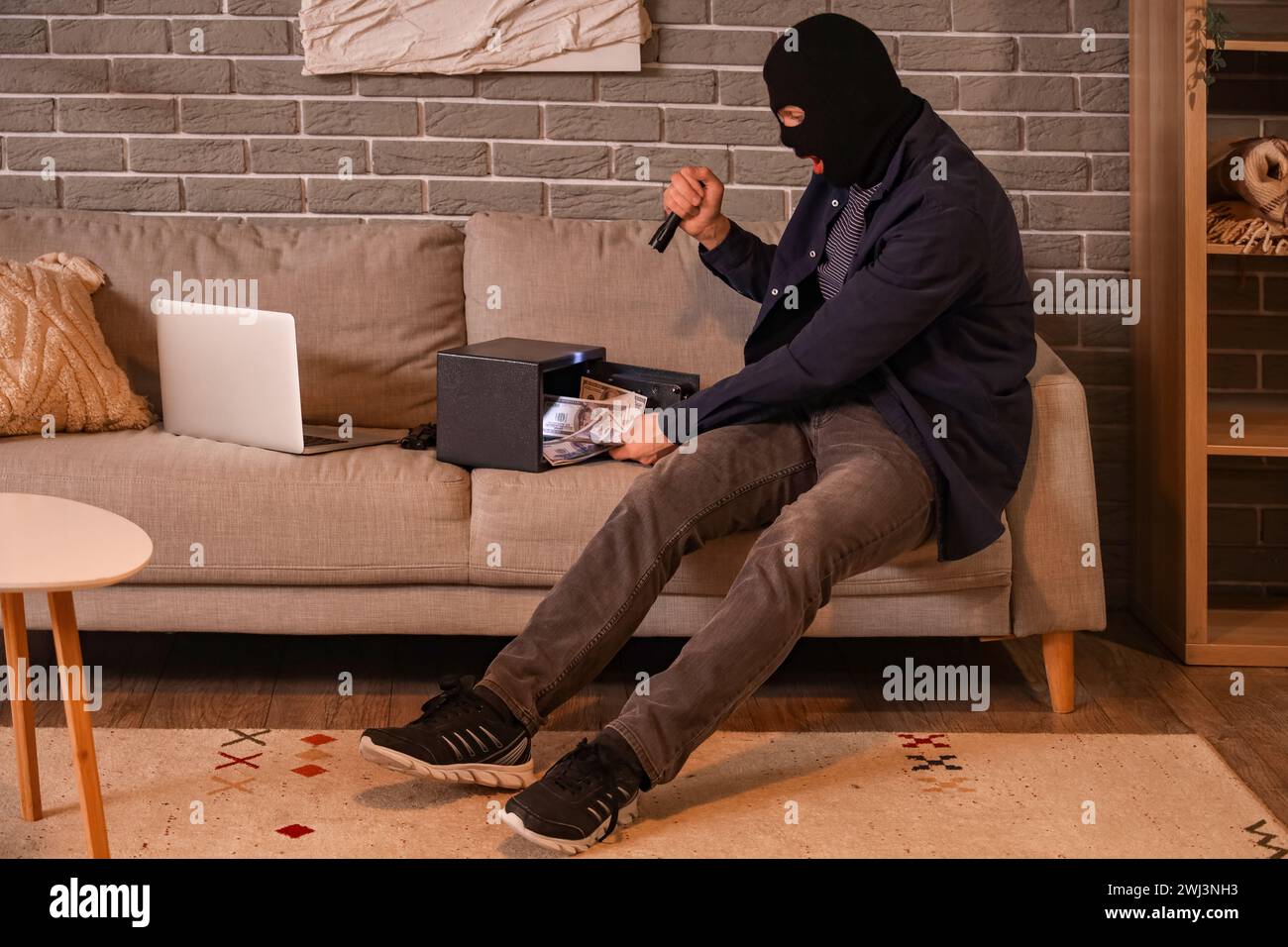 Thief stealing money from safe hi-res stock photography and images - Alamy
