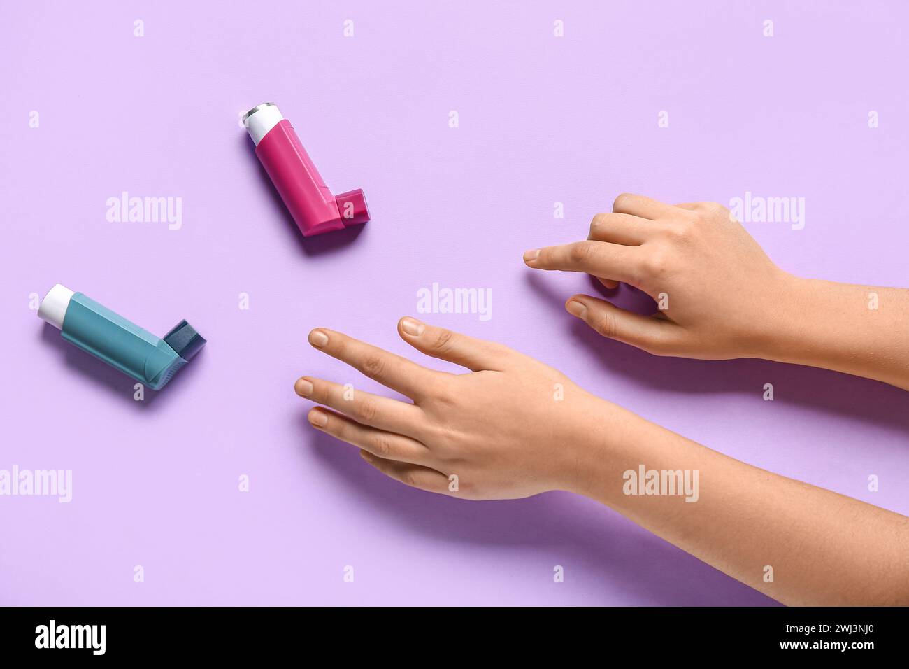 Child's hands with asthma inhalers on lilac background Stock Photo - Alamy