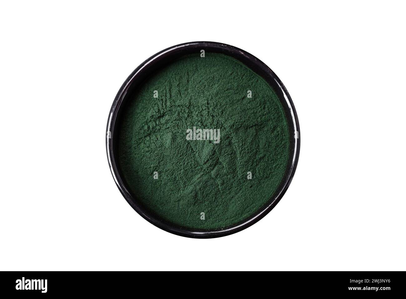 Spice, green color spirulina in the form of powder in a black bowl ...