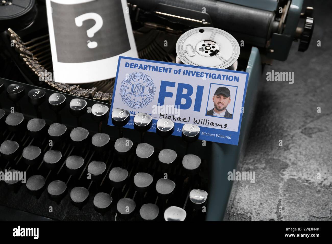 Retro typewriter, document of FBI agent and question mark on dark ...