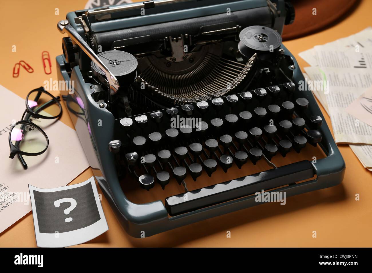 Retro typewriter, eyeglasses and question mark on color background ...