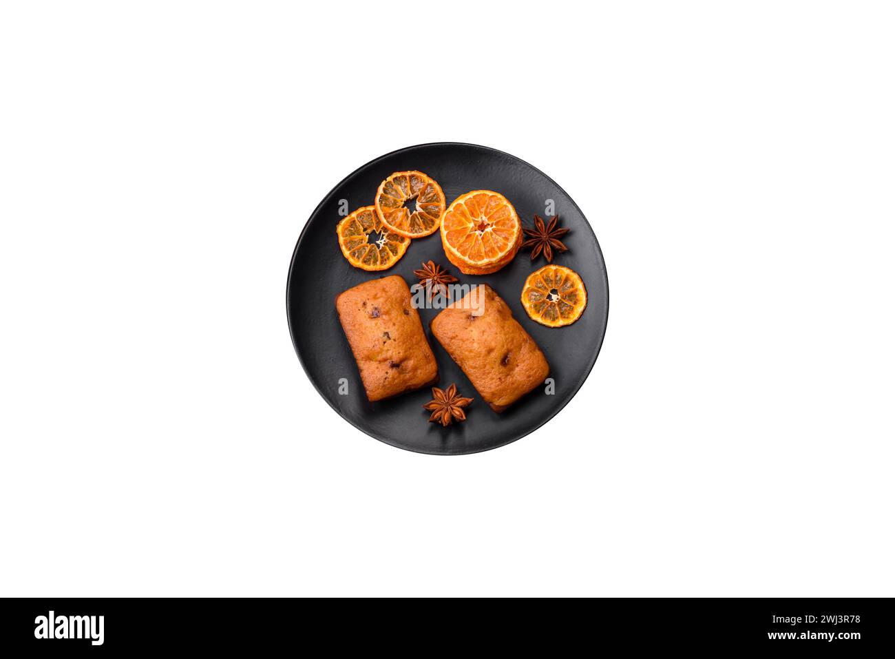 Delicious chocolate muffins and dried round shaped slices of tangerine ...