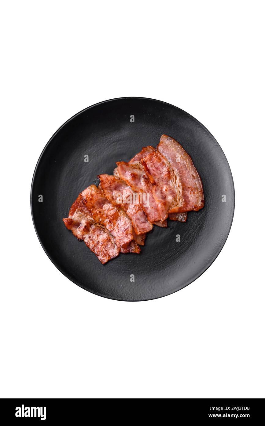 Delicious fresh fried bacon stripes with spices Stock Photo - Alamy