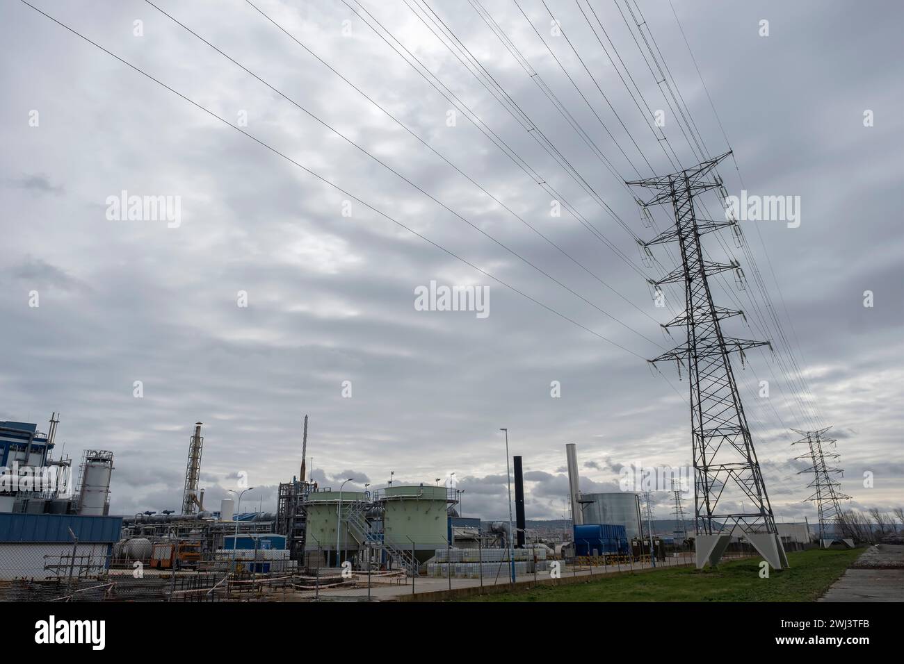 an electric tower of a high voltage line in an industrial area with a ...