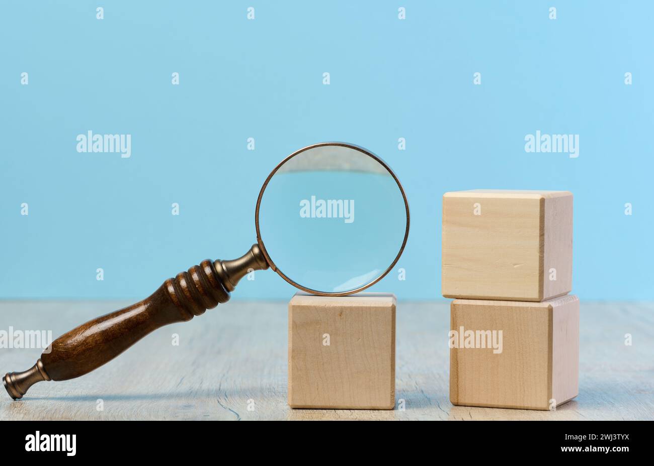 Magnifying glass wooden cubes hi-res stock photography and images - Alamy