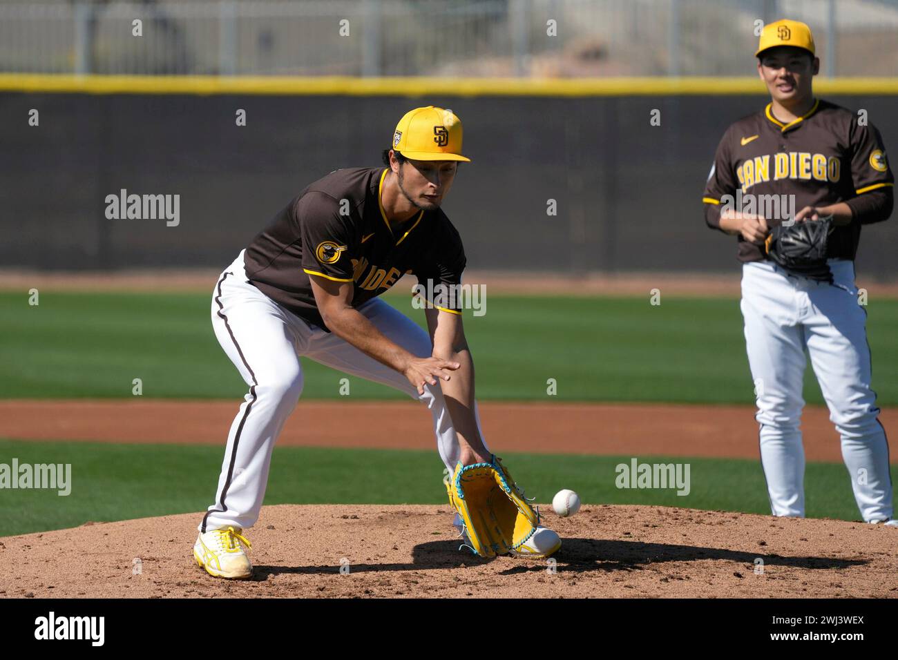 San Diego Padres starting pitcher Yu Darvish, left, of Japan, fields a ...