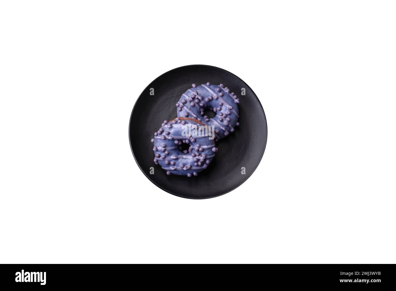 Delicious sweet donut of purple color in glaze and with lilac balls ...