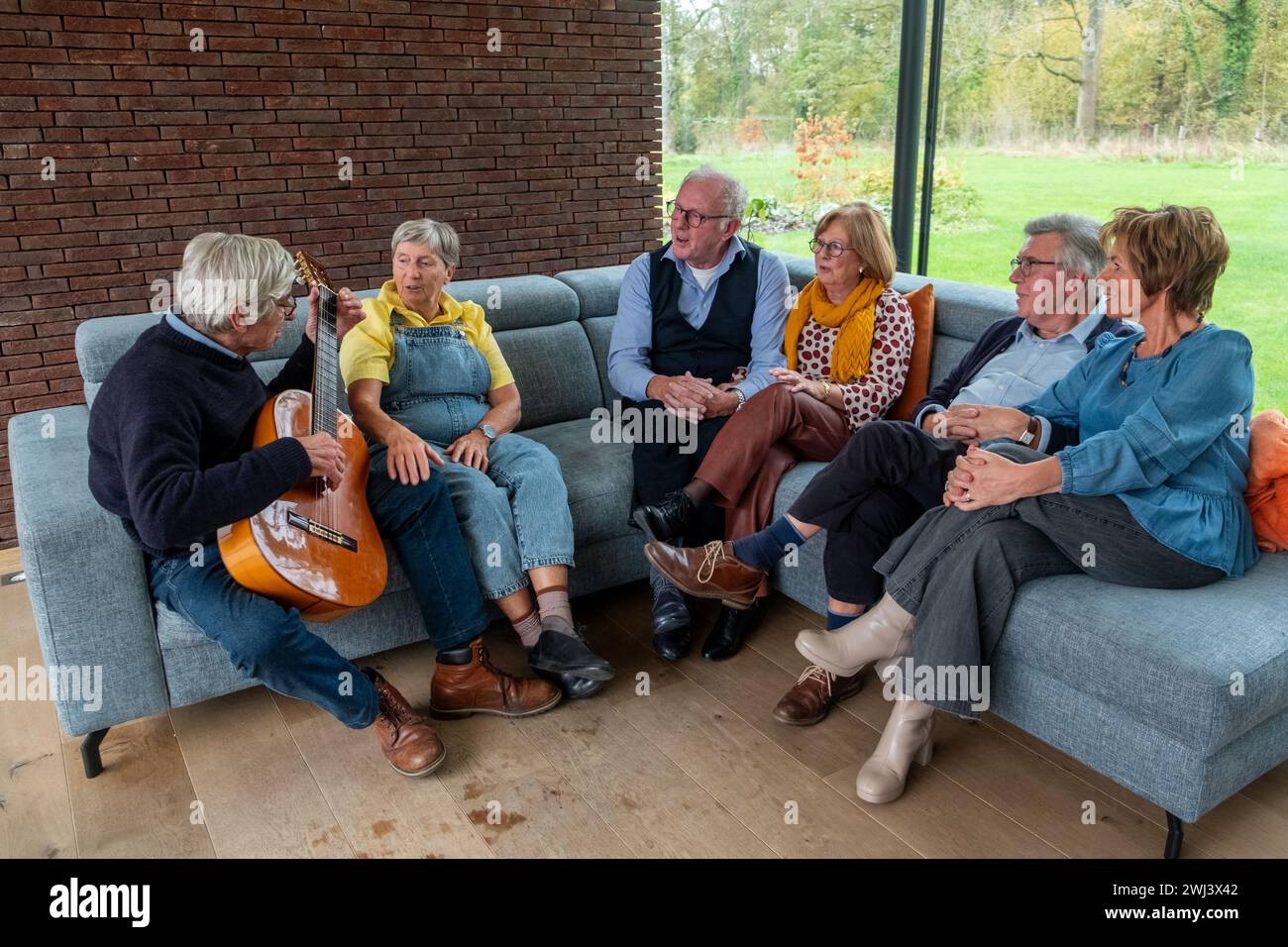 Melodies of Memory: Seniors Sharing Stories and Songs Stock Photo - Alamy