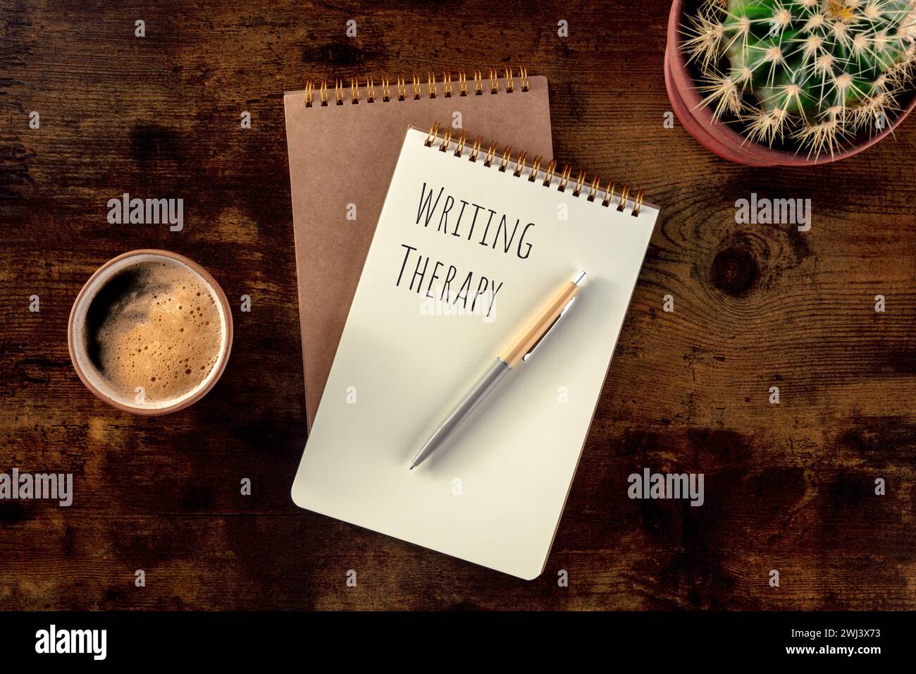 Writing Therapy. Notebook with a pen, coffee, and a plant, overhead ...