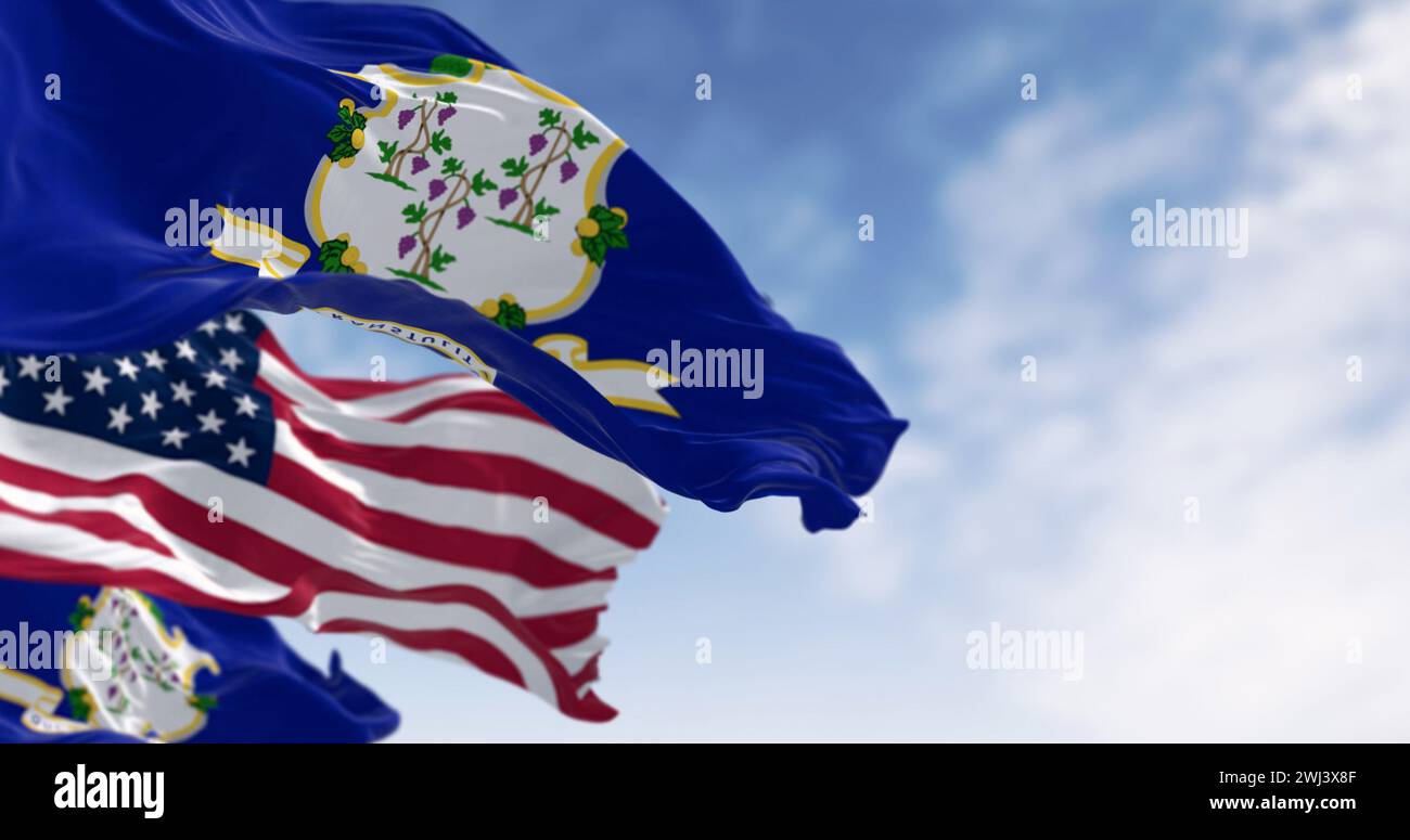 Connecticut and the United States flags waving in the wind on a clear ...