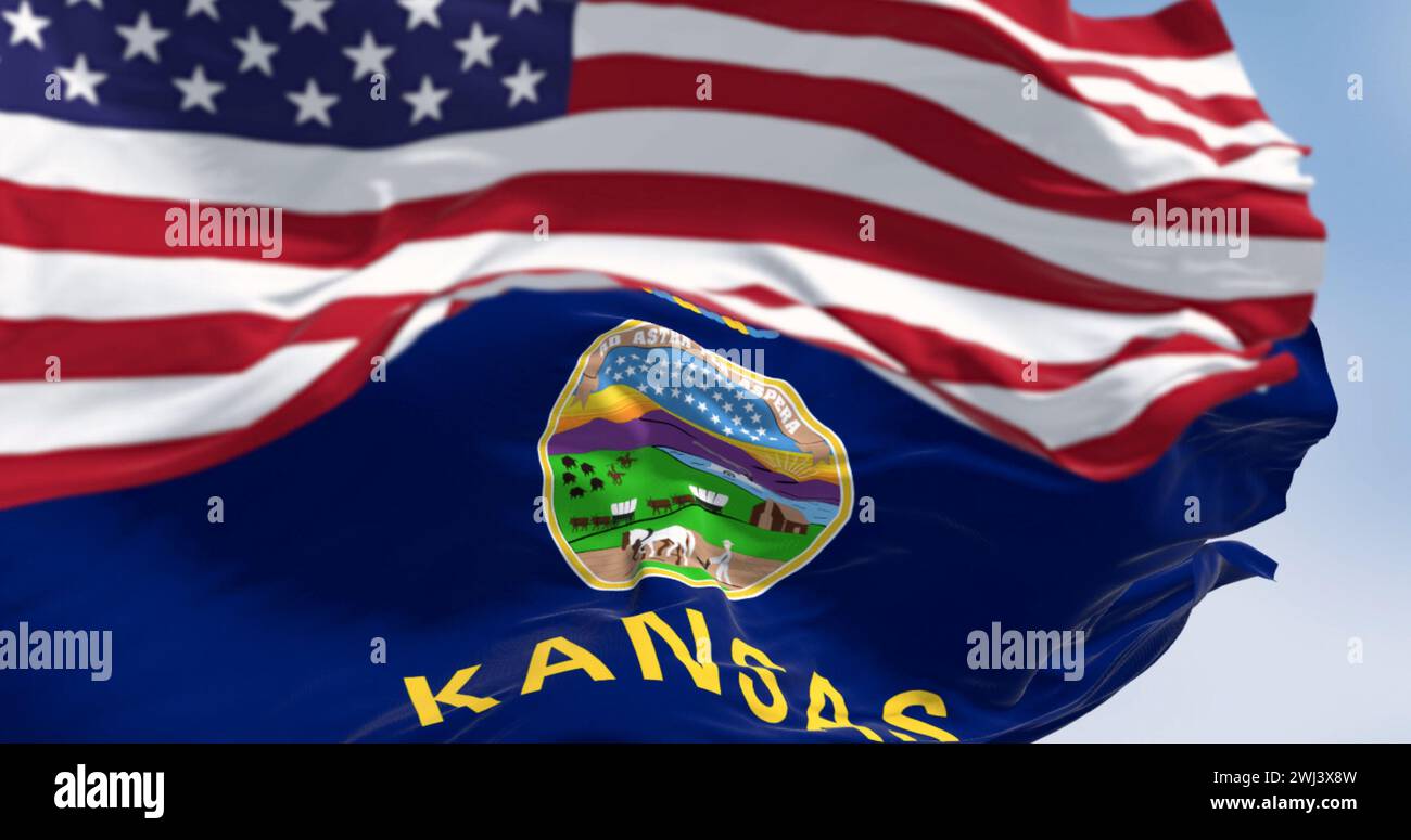 Kansas state flag and the American flag waving in the wind on a clear ...