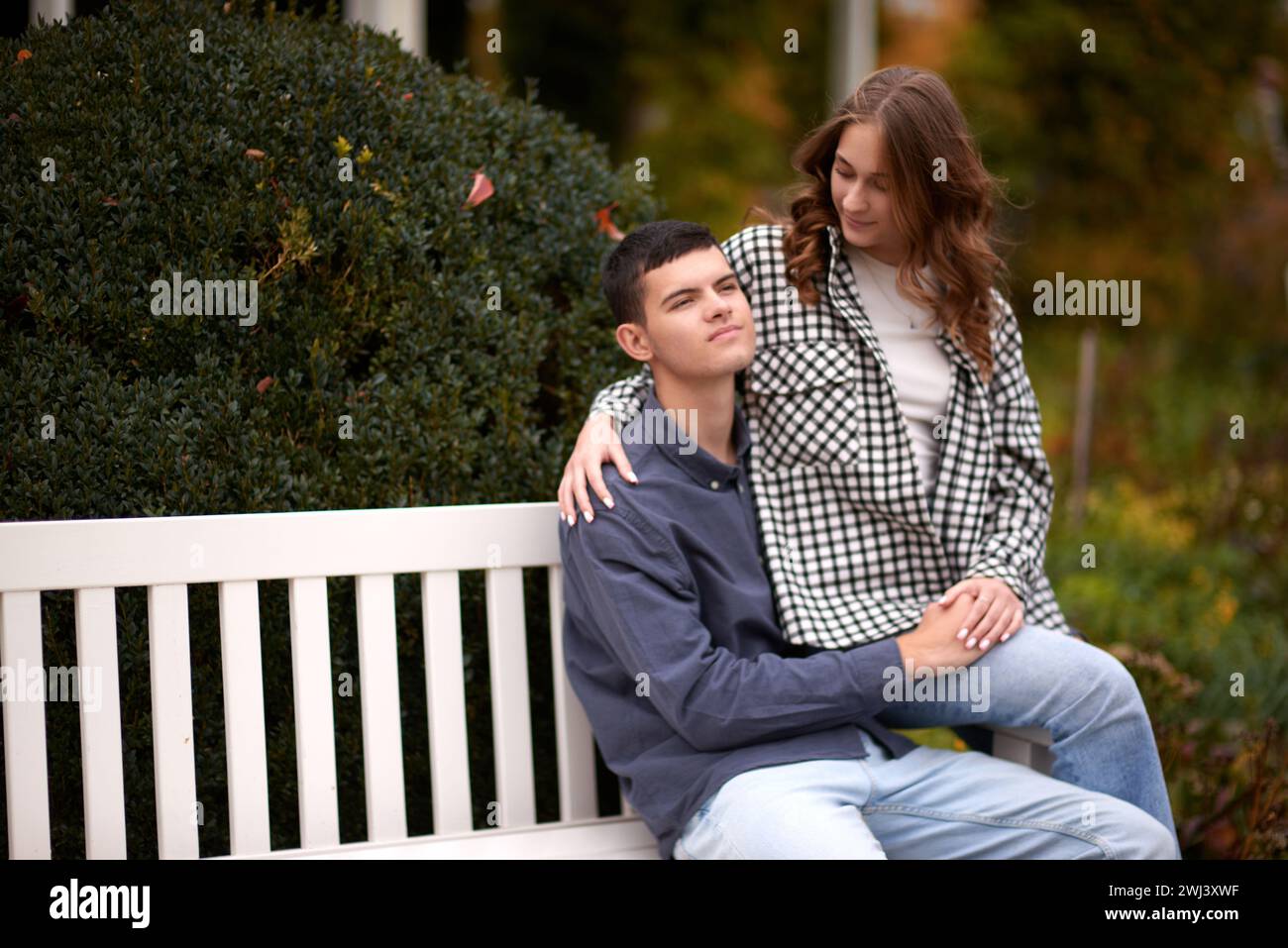 Autumn Romance: Young Couple Embracing and Kissing on Park Bench. Young ...
