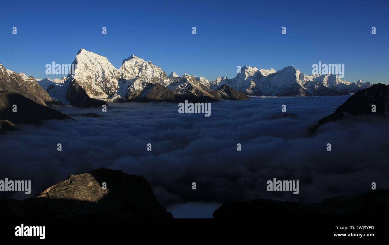 Mountain ranges of the Himalayas and sea of fog. View from Gokyo Peak ...
