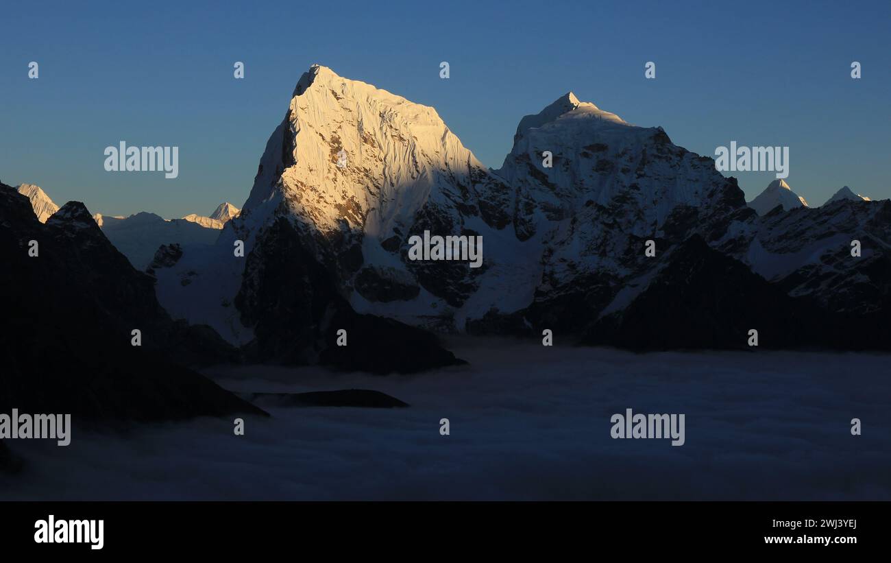 Sun lit peak of Mount Cholatse at sunset, Nepal Stock Photo - Alamy