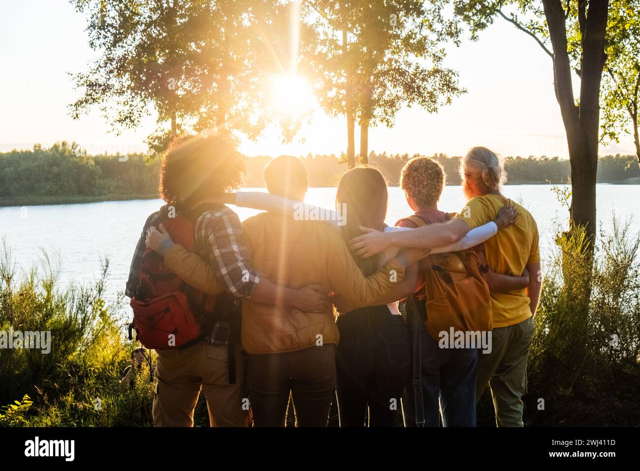 Sunset Comradeship: Friends United by Lakeside Views Stock Photo - Alamy